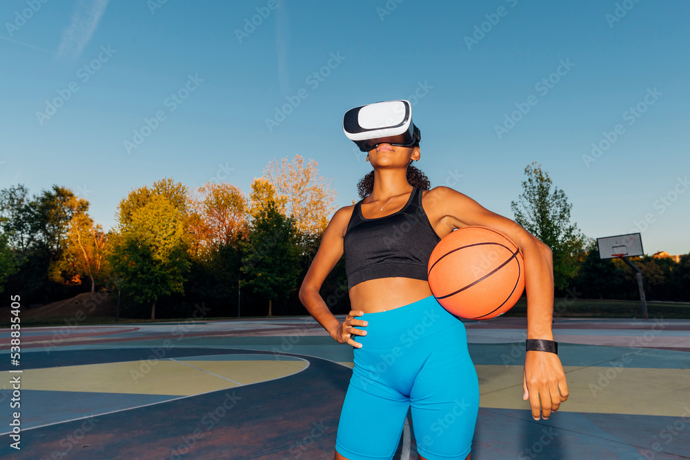 Young basketball player with ball and VR Goggles at sunset Stock Photo ...