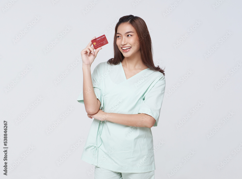 Happy asian woman patient showing credit card isolated on white ...