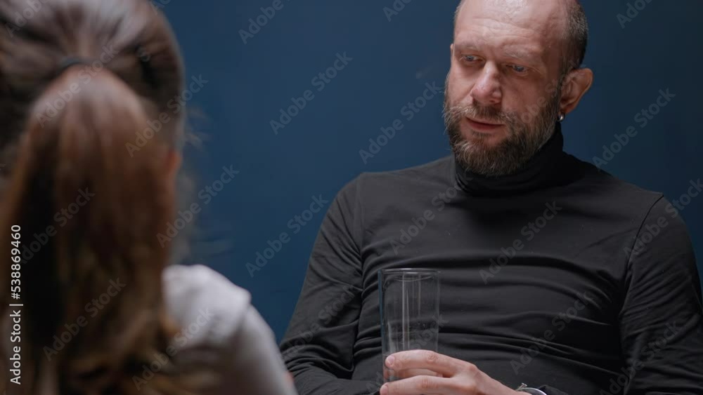 Arrested criminal detained murder drinks glass of water. Police officer ...