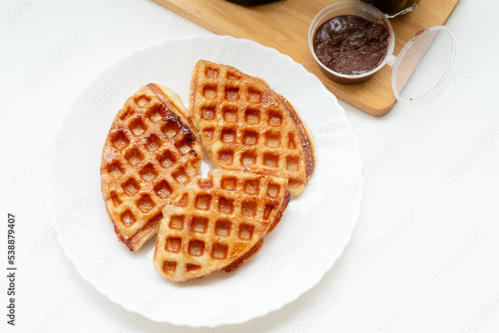 Waffle croissants (also called croffles) coated in melted sugar on a ...
