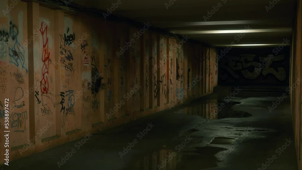 Video. Empty deserted underpass with painted walls. Gloomy view of ...