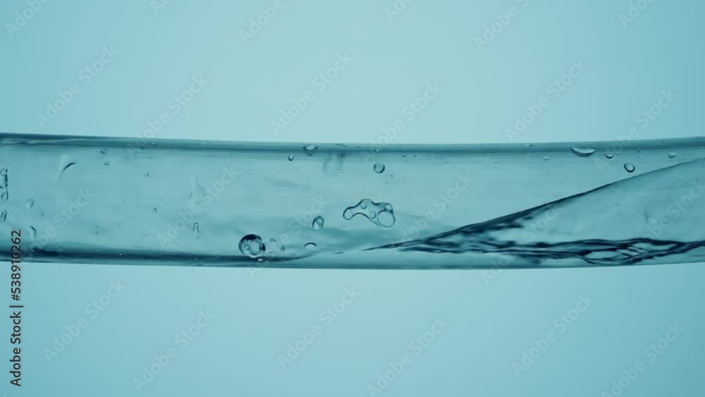 Stockvideo Water flowing in stream inside transparent glass tube on an ...
