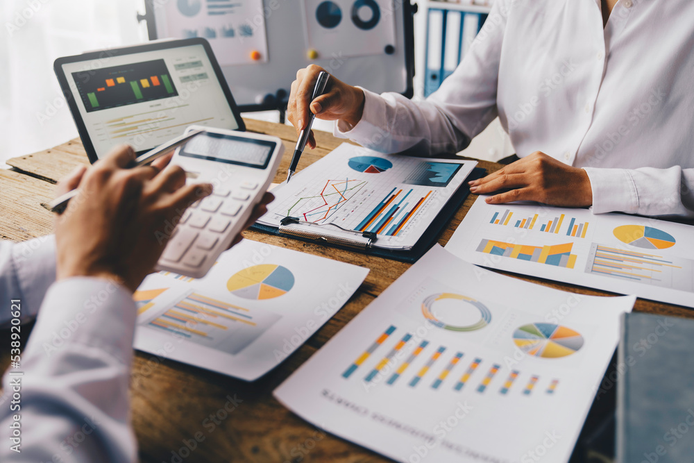 Financial analysts analyze business financial reports on digital ...