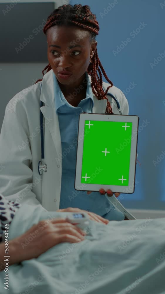 Vertical video: Analysis doctor showing tablet with green screen to ...