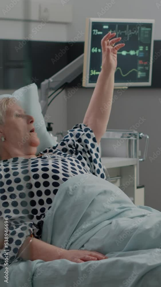 Vertical video: Old woman breathing heavily and asking for medical ...