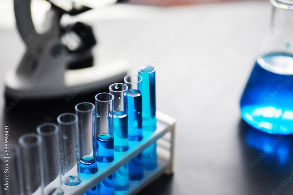 Test tube with blue liquid on the laboratory table. Examination of ...