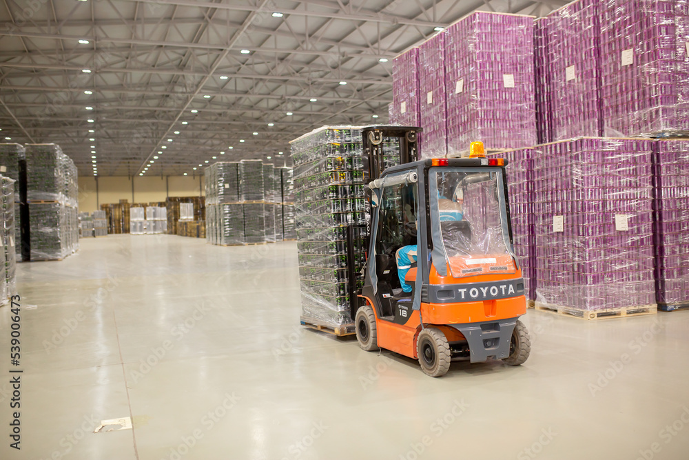 Loader loading packaged products at the factory. Conveyor line for the ...