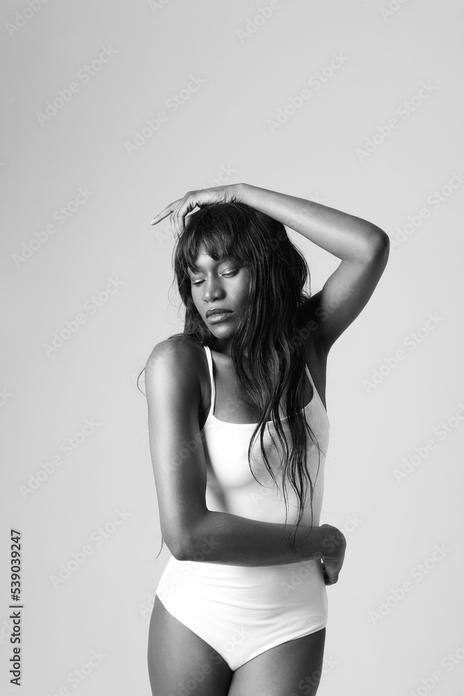 Gorgeous Young Woman With Perfect Body Posing Over White Wall Black