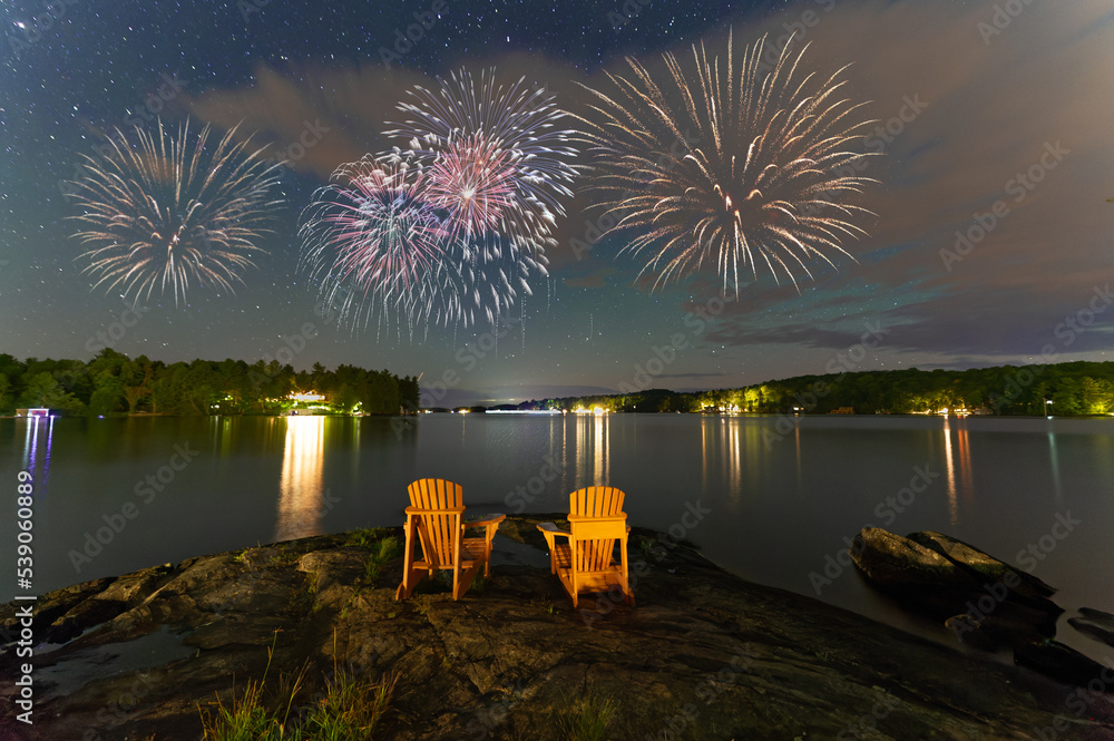 Canada Day fireworks over two Adirondack chairs in Muskoka, Ontario ...