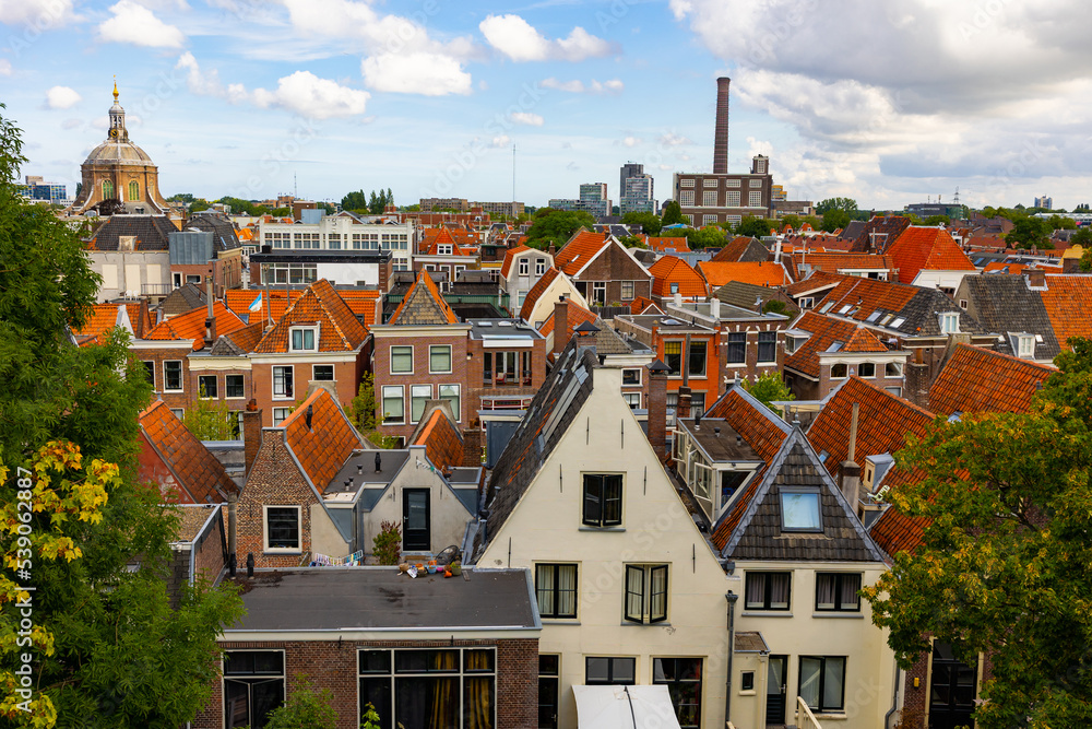 Scenic cityscape of Leiden with brownish tiled roofs of residential ...