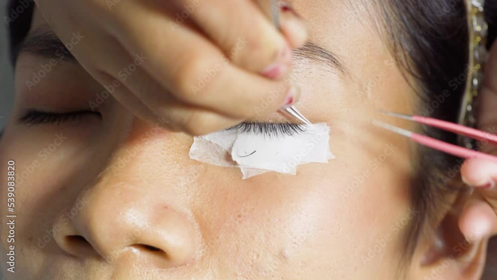 Woman doing eyelash extension treatment in salon Stock Video | Adobe Stock