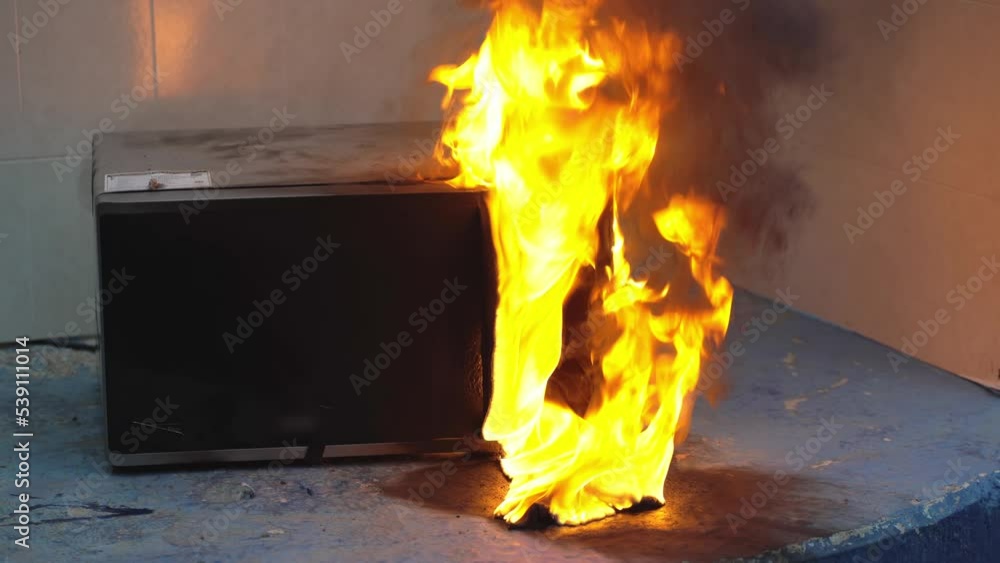 microwave oven on fire. the concept of fire in the kitchen and ...