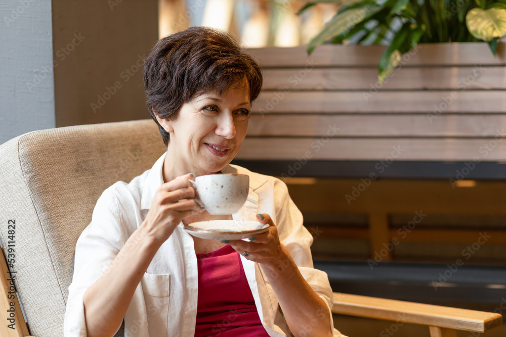 Beautiful adult Jewish woman middle age holding cup with beverage. jew ...