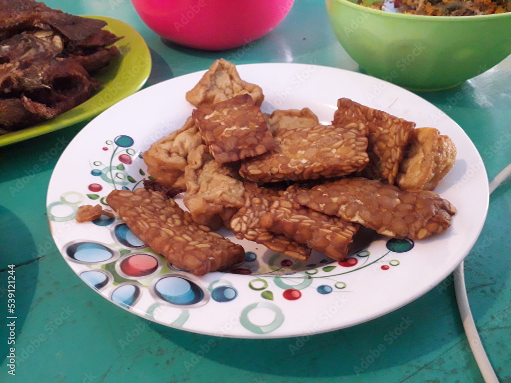 Deep fried tempeh or Tempe Mendoan, is a traditional food made from ...