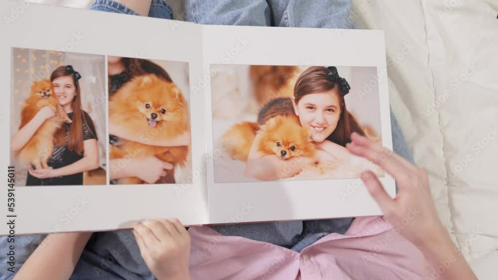 top view. flip through a photobook with photos of a family photo shoot ...