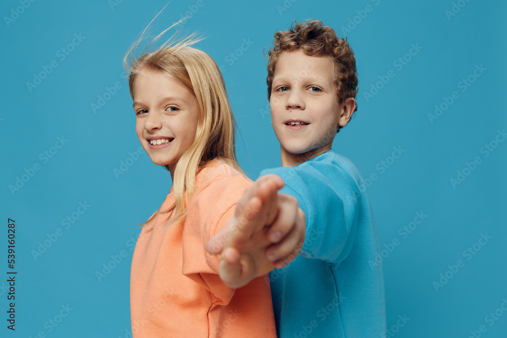 cute, beautiful, happy children stand on a blue background with an ...