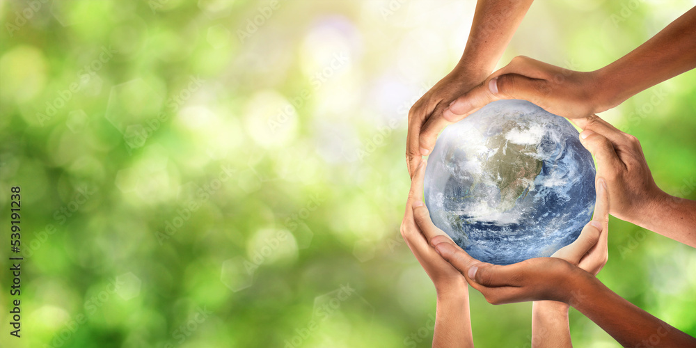 Conceptual symbol of multiracial human hands surrounding the Earth ...