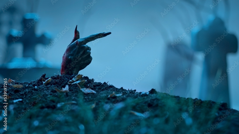 Zombie hand pointing to something out of grave. Holiday event halloween ...