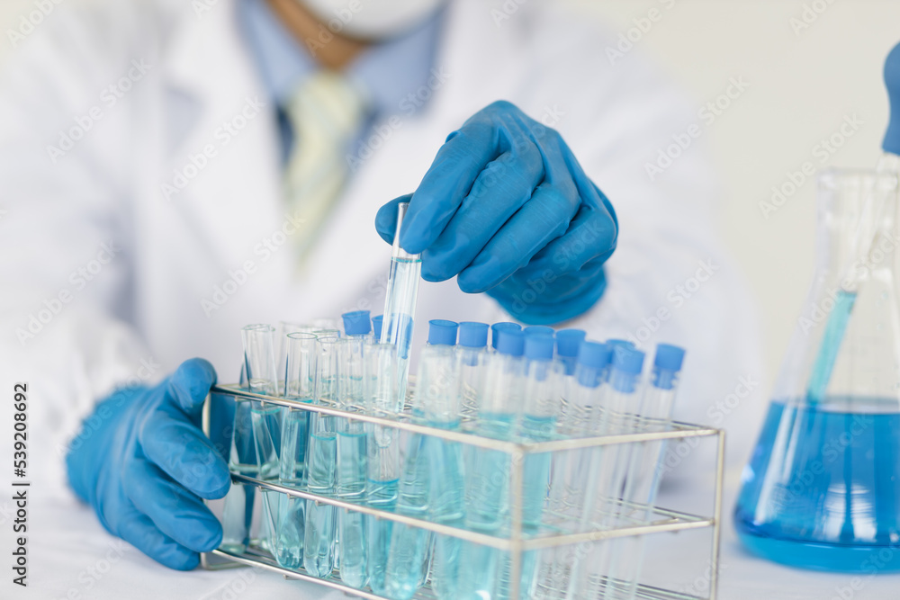 Scientists work with in vitro reagents in laboratories and draw ...