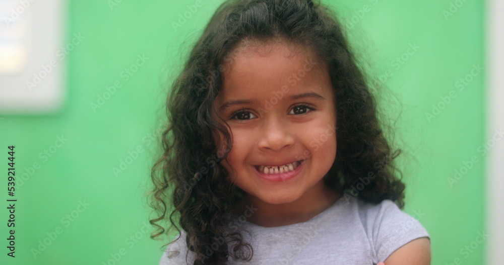 Cute hispanic little girl child portrait smiling close-up face Stock Photo | Adobe Stock