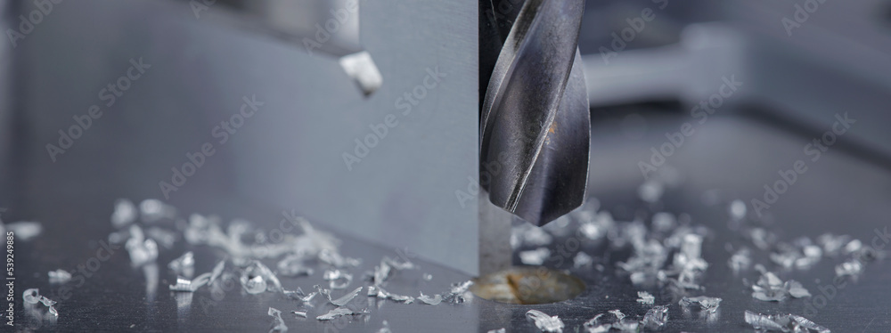 metal drill bit make holes in steel billet on industrial drilling ...