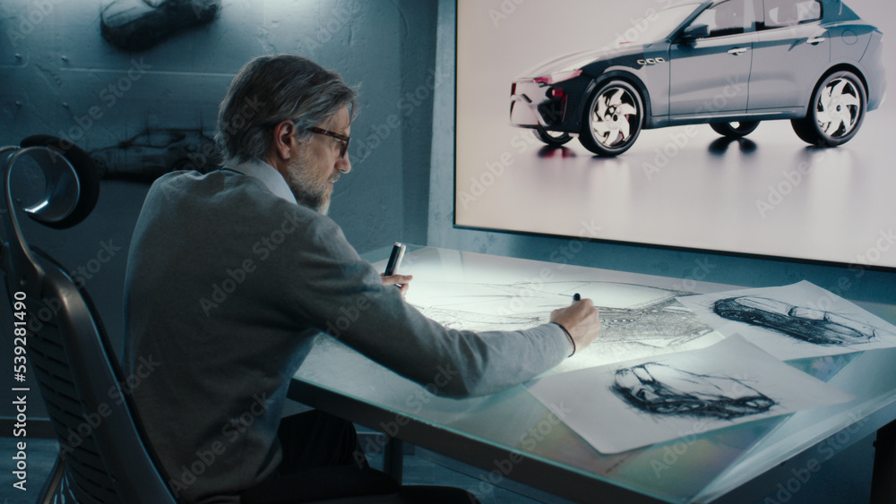 Automotive graphic designer draws sketch of the prototype model of a ...
