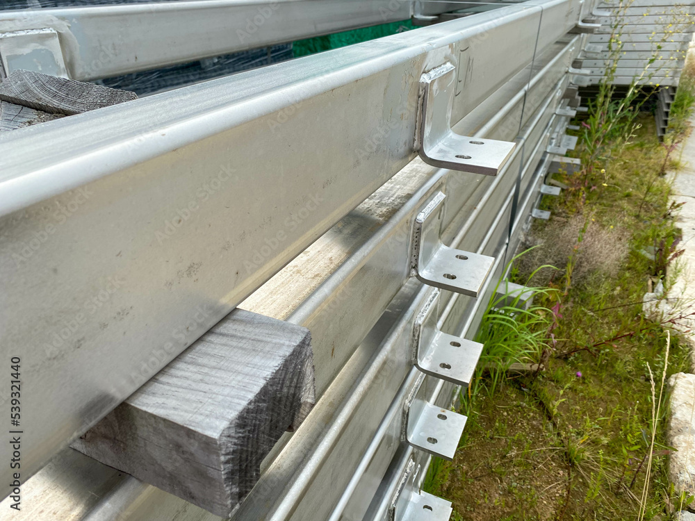 Metal structures for construction and pipes on pallets in an open-air ...