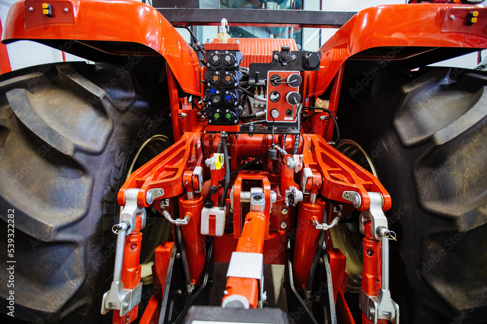 Fotka „Rear view of modern agricultural tractor in hangar. Hydraulic ...