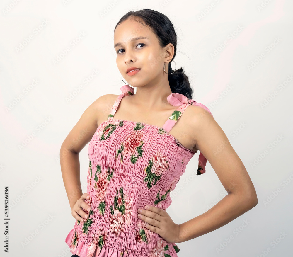 a young teen cute girl in a pink dress posing for a picture with her ...