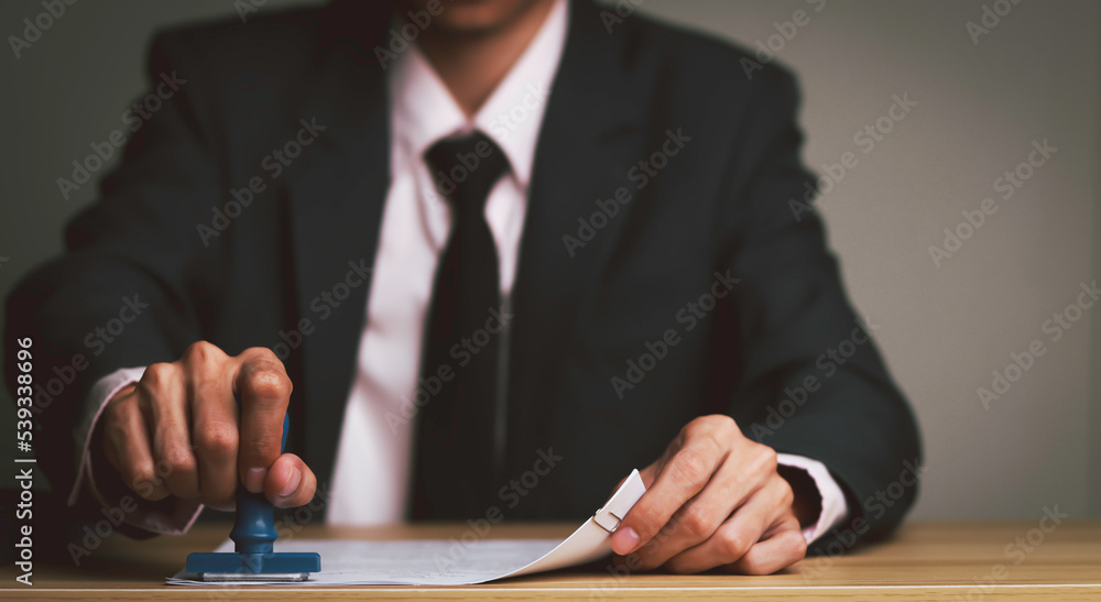 Businessman person with a stamp of approval on a public notarization ...