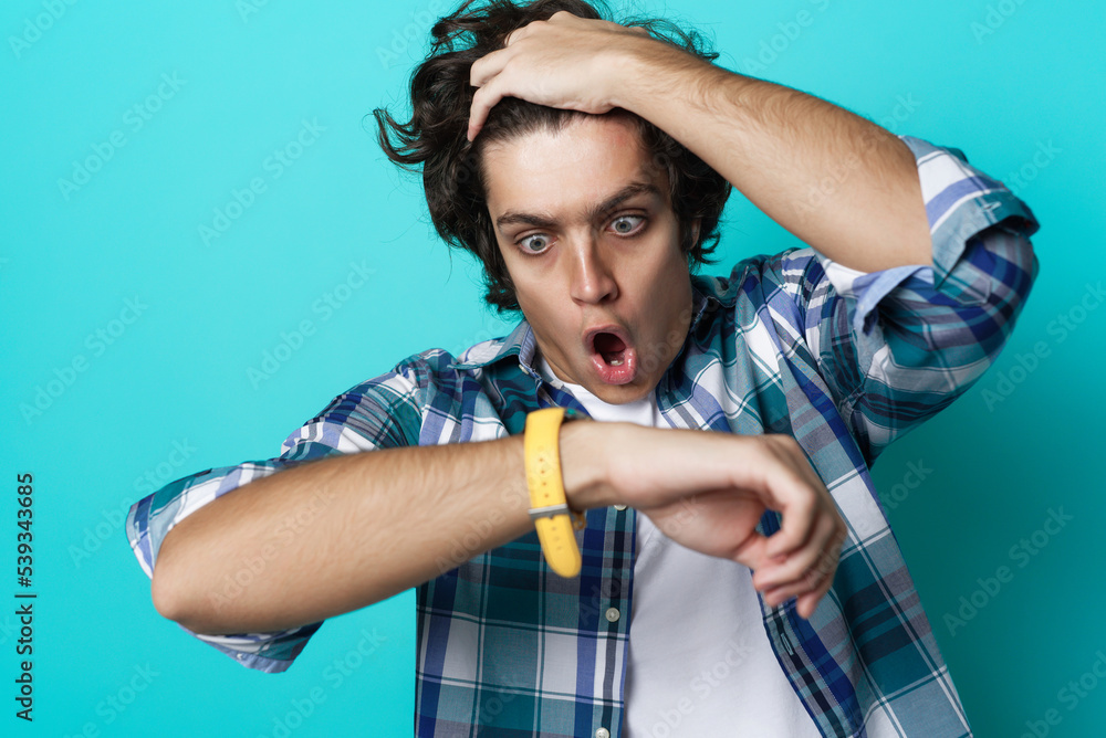 Shocked teenage man stunned at the time, being late for school or a ...