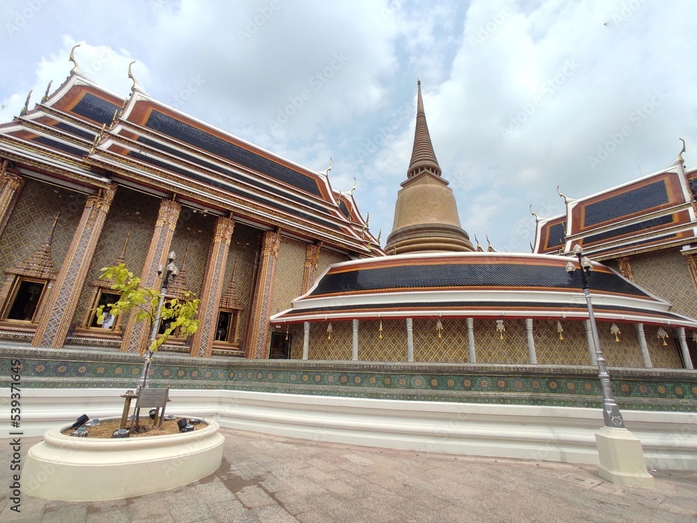 Golden pagoda and the curved walkway around the circular cloister of ...
