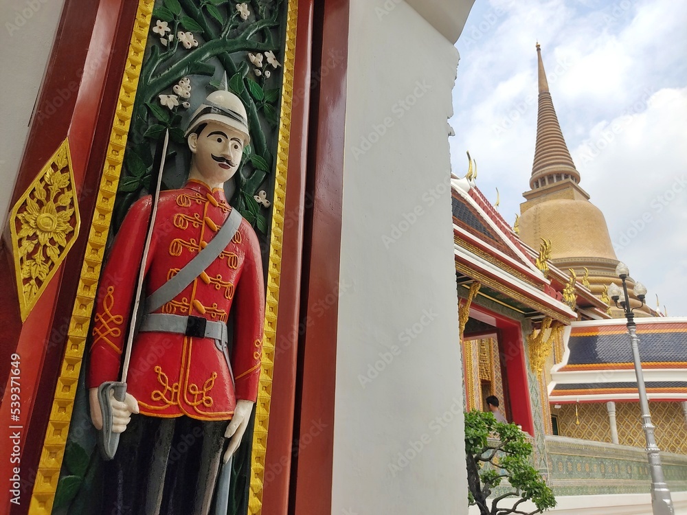 The front entrance with an image of watchman in Wat Ratchabophit, The ...