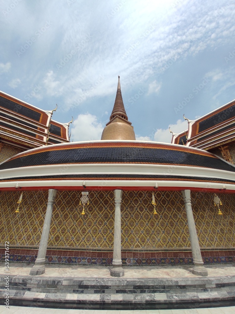 Golden pagoda and the curved walkway around the circular cloister of ...