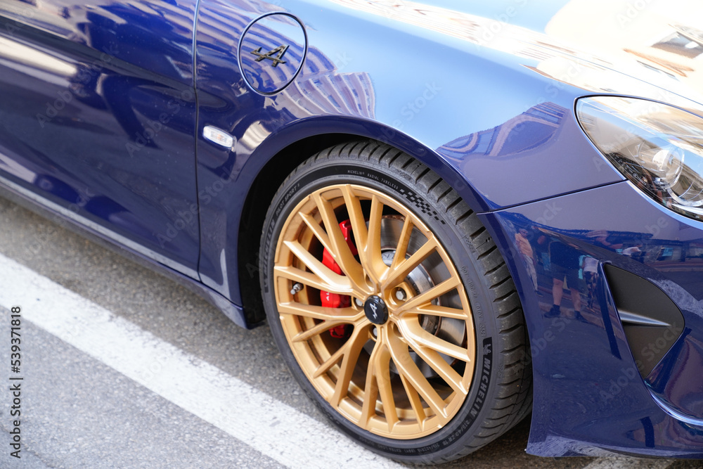 Alpine A110 sports car logo brand and text sign golden front wheel ...