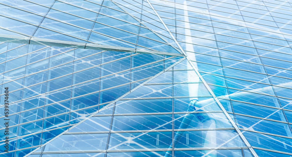 Sustainable glass building and wind power concept. Wind turbine and ...