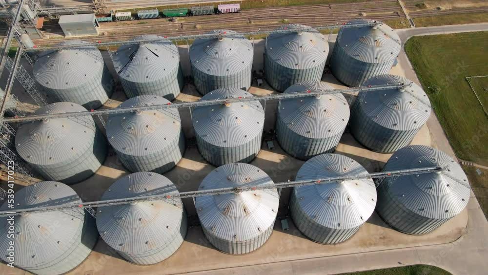 Powerful plant with huge silo tanks and railways for cargo trains ...
