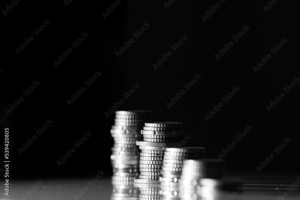 Coin tower made of European currency against dark background, set up ...