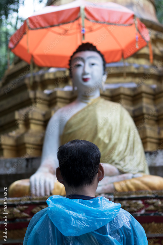 Man Asian traveller tourist praying and paying homage to a Buddha ...