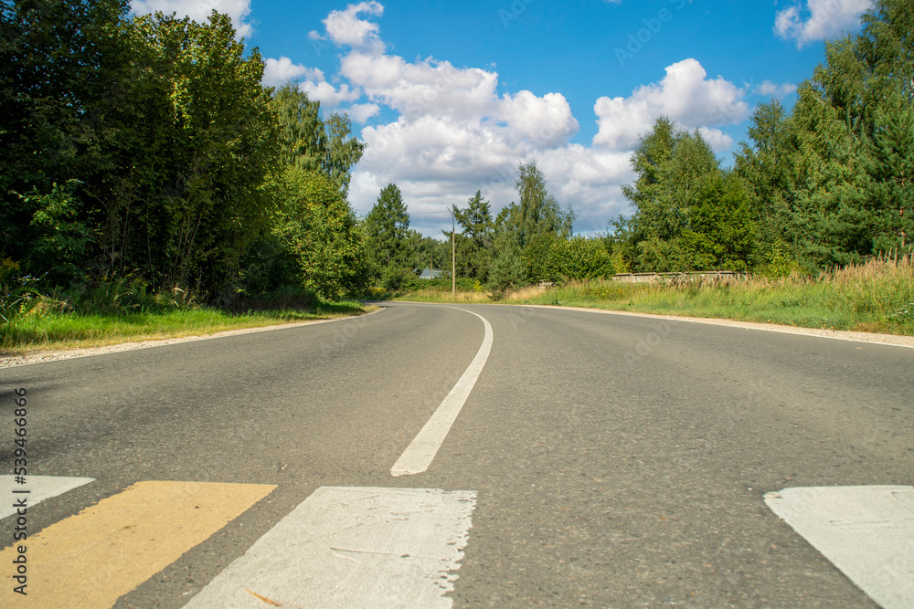 Close-up of a small empty highway in the countryside. Road turning ...