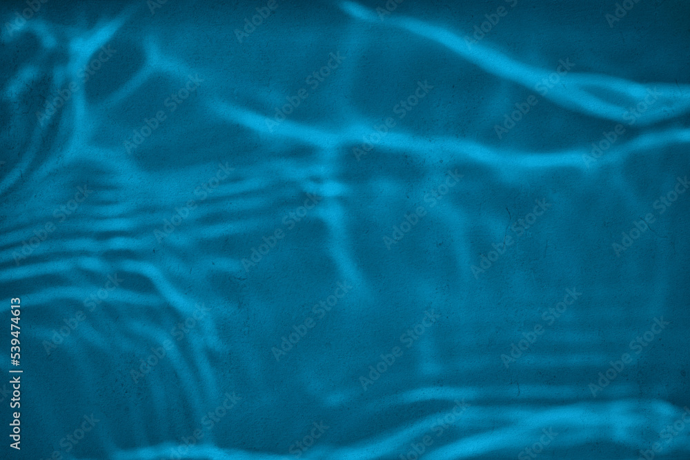 Shadow and light water caustic effect on blue concrete wall texture ...