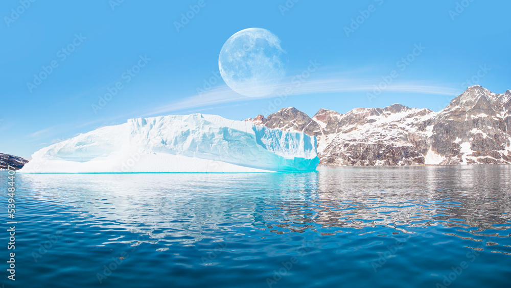 View of Greenland glaciers and iceberg from the village of Kulusuk with ...
