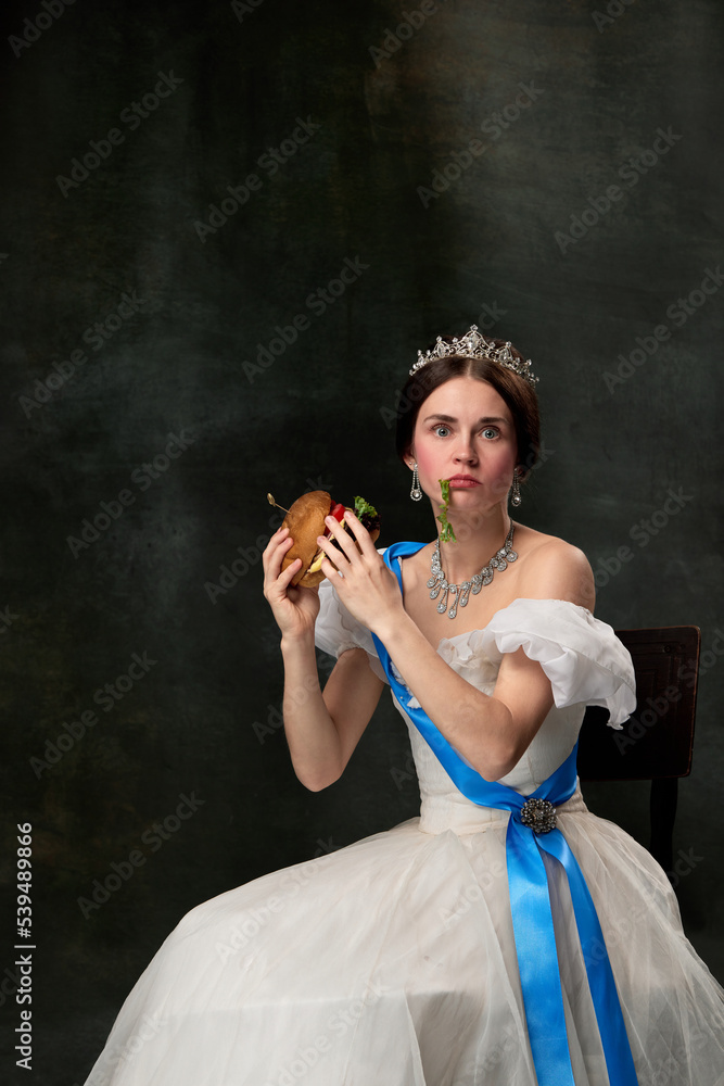Fast food or dieting. Young funny girl like queen or princess in white ...