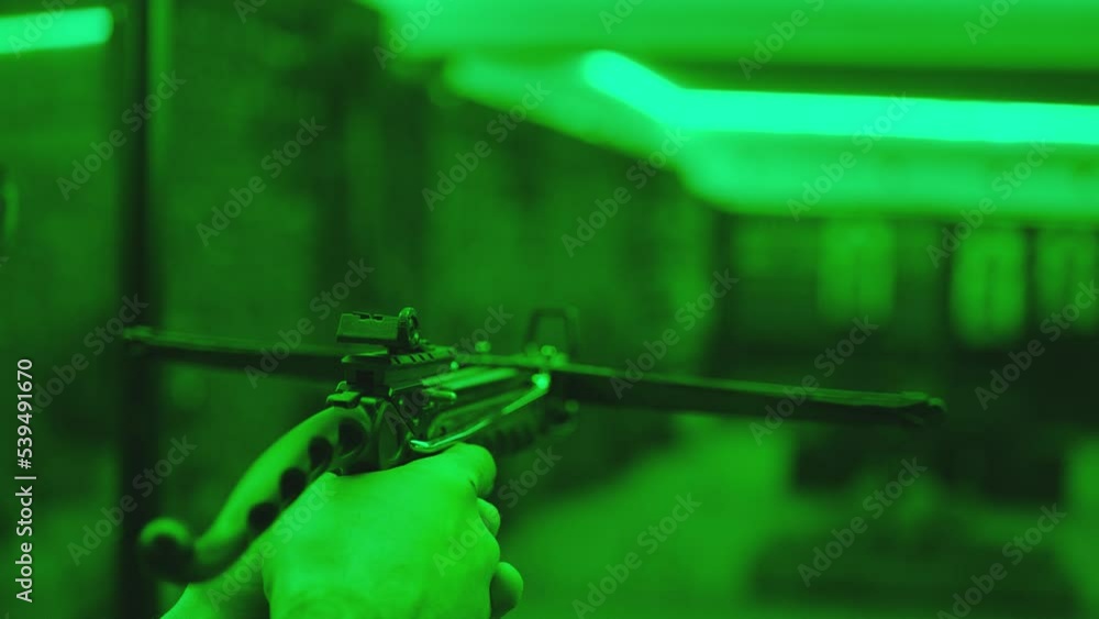 Firing a crossbow . Player or shooter loading arrow in arbalet and ...