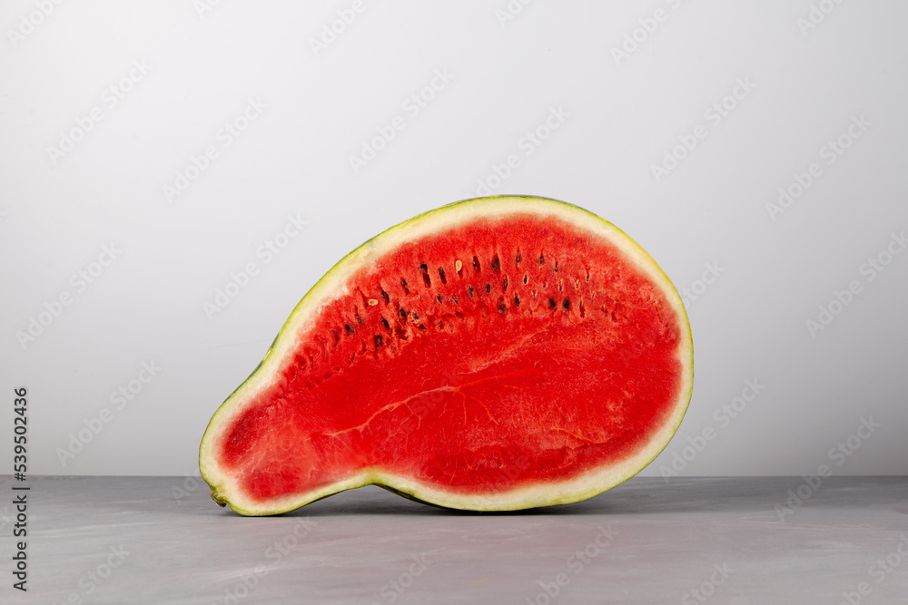 Half of pear-shaped watermelon. Deformed ugly watermelon. Red pulp and ...