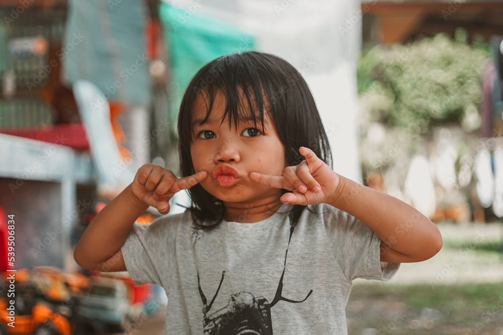 portrait of cute little girl sending an air kiss at home. A little cute ...