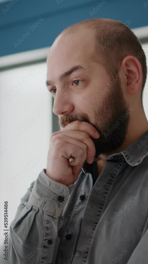 Vertical video: Close up of architect thinking about building strategy ...