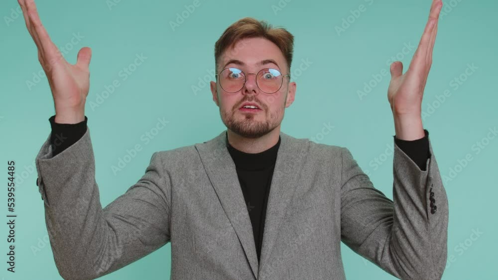 Excited amazed business man in jacket touching head and showing ...