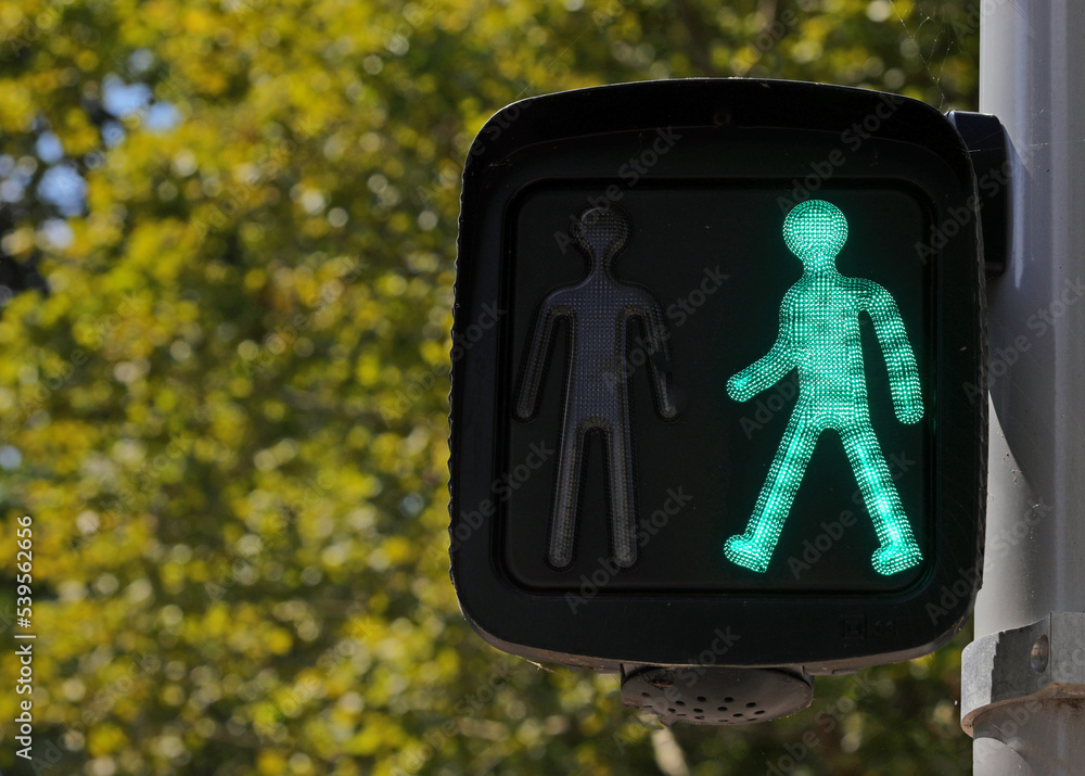 bright green traffic light man in the city Stock Photo | Adobe Stock