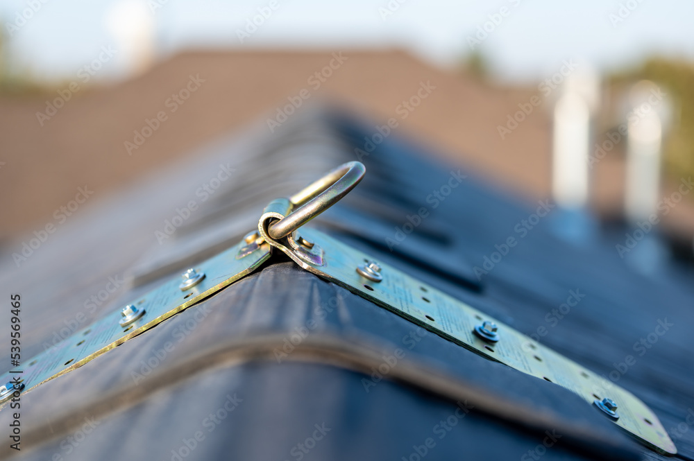Selective focus on a metal temporary anchor installed on the peak of a ...